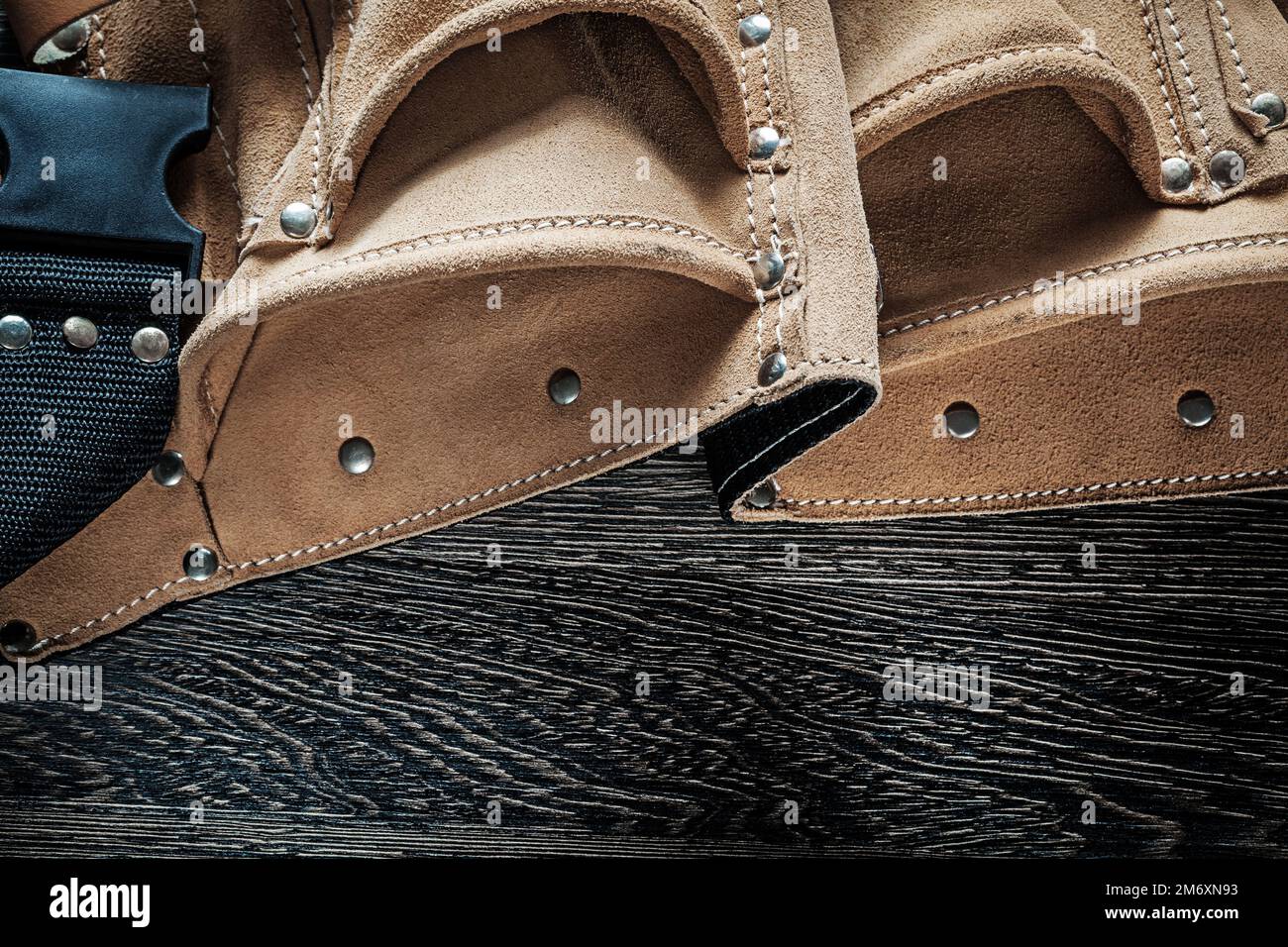 Leather construction belt on black board Stock Photo - Alamy