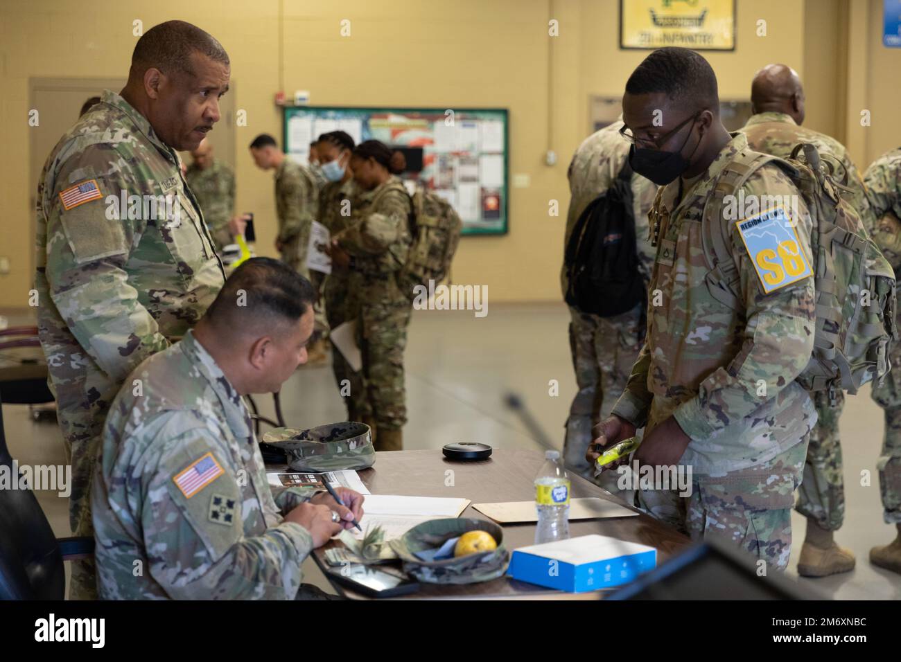 Pfc. Emeka Watson (right), a military police officer with the 661st ...