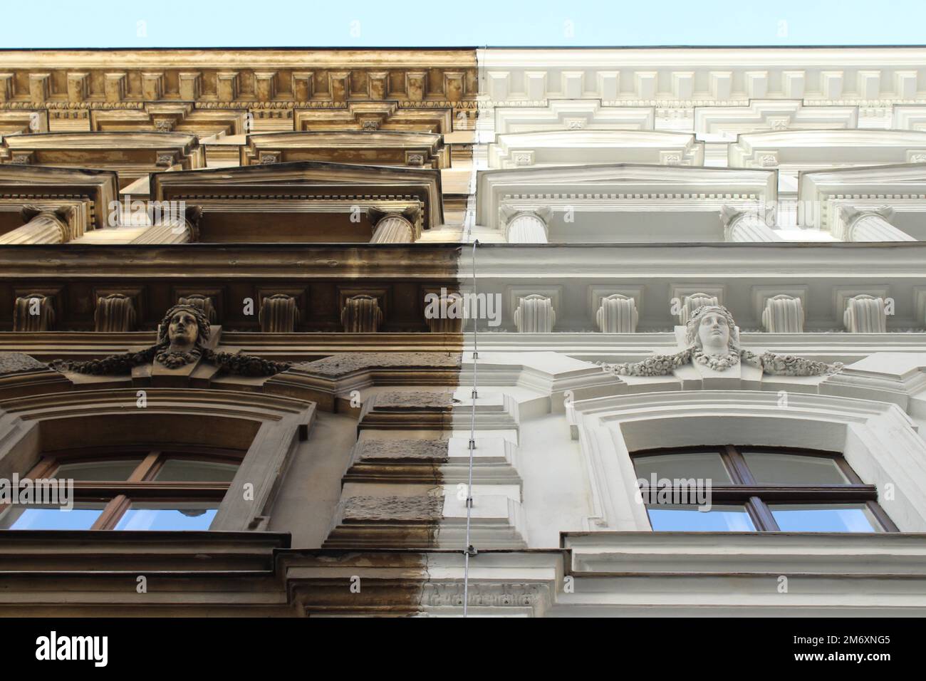 A low angle shot of an old building painted white only in half Stock ...