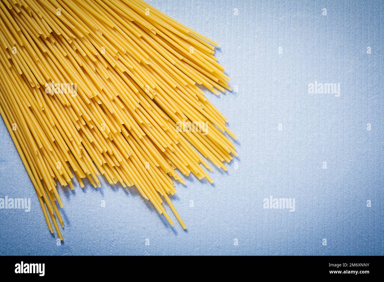 Long spaghetti on blue hi-res stock photography and images - Alamy