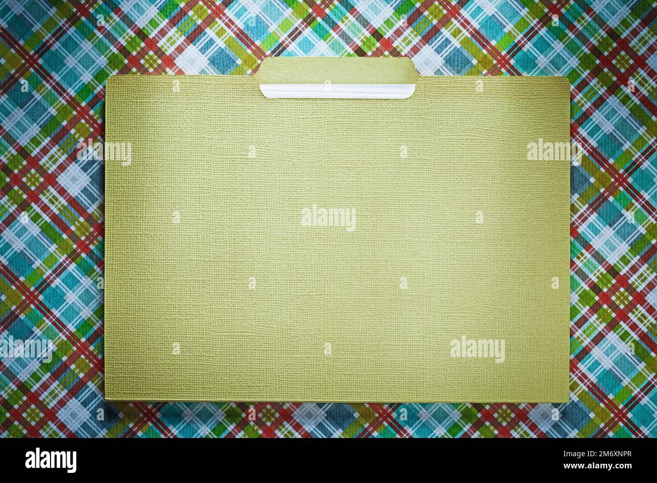 Manila file folder on checked background Stock Photo - Alamy