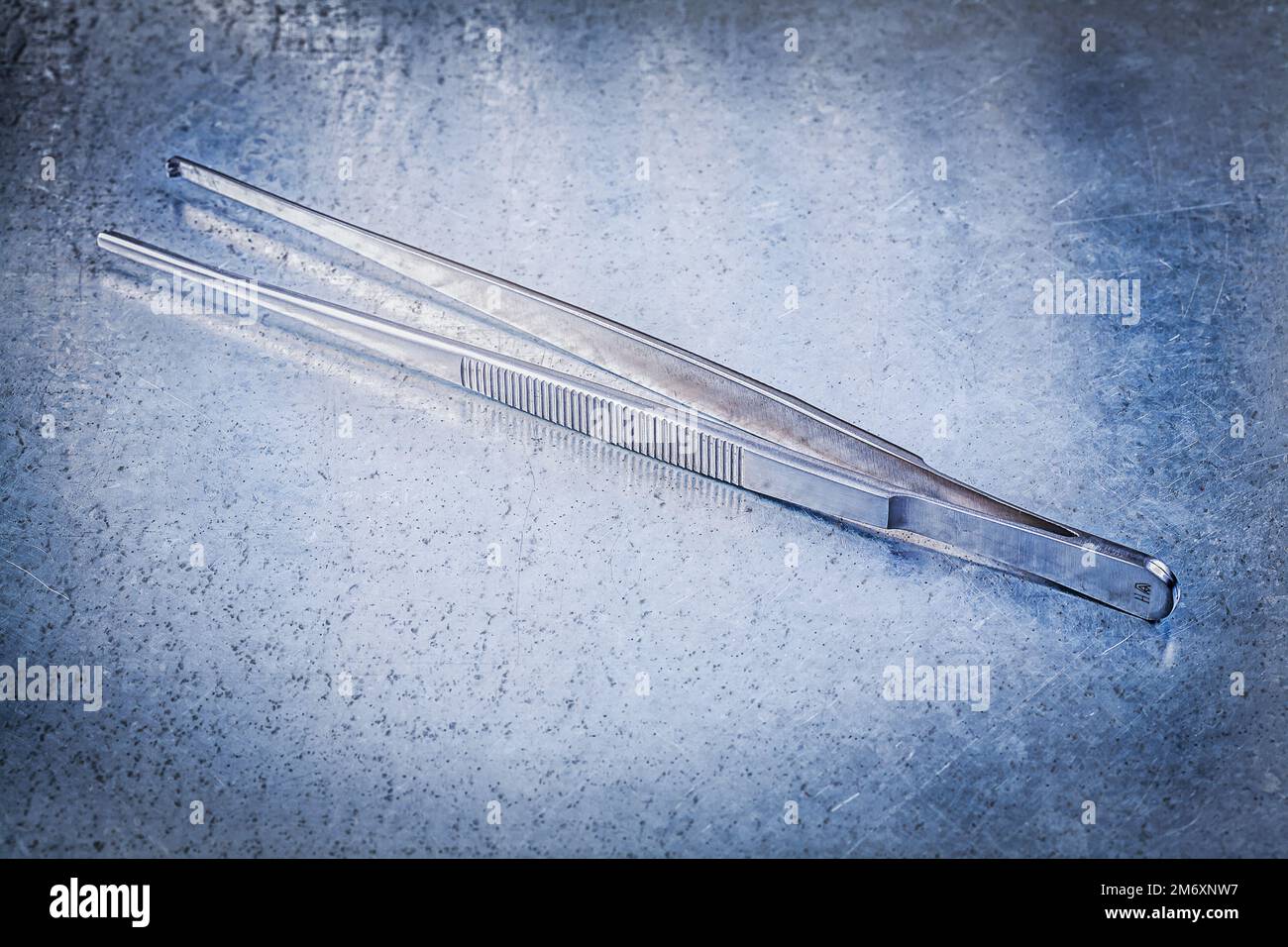 Medical forceps on metallic background medicine concept Stock Photo - Alamy