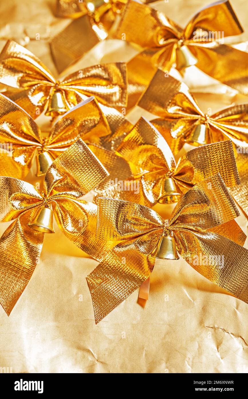 many golden bows on paper background Stock Photo - Alamy
