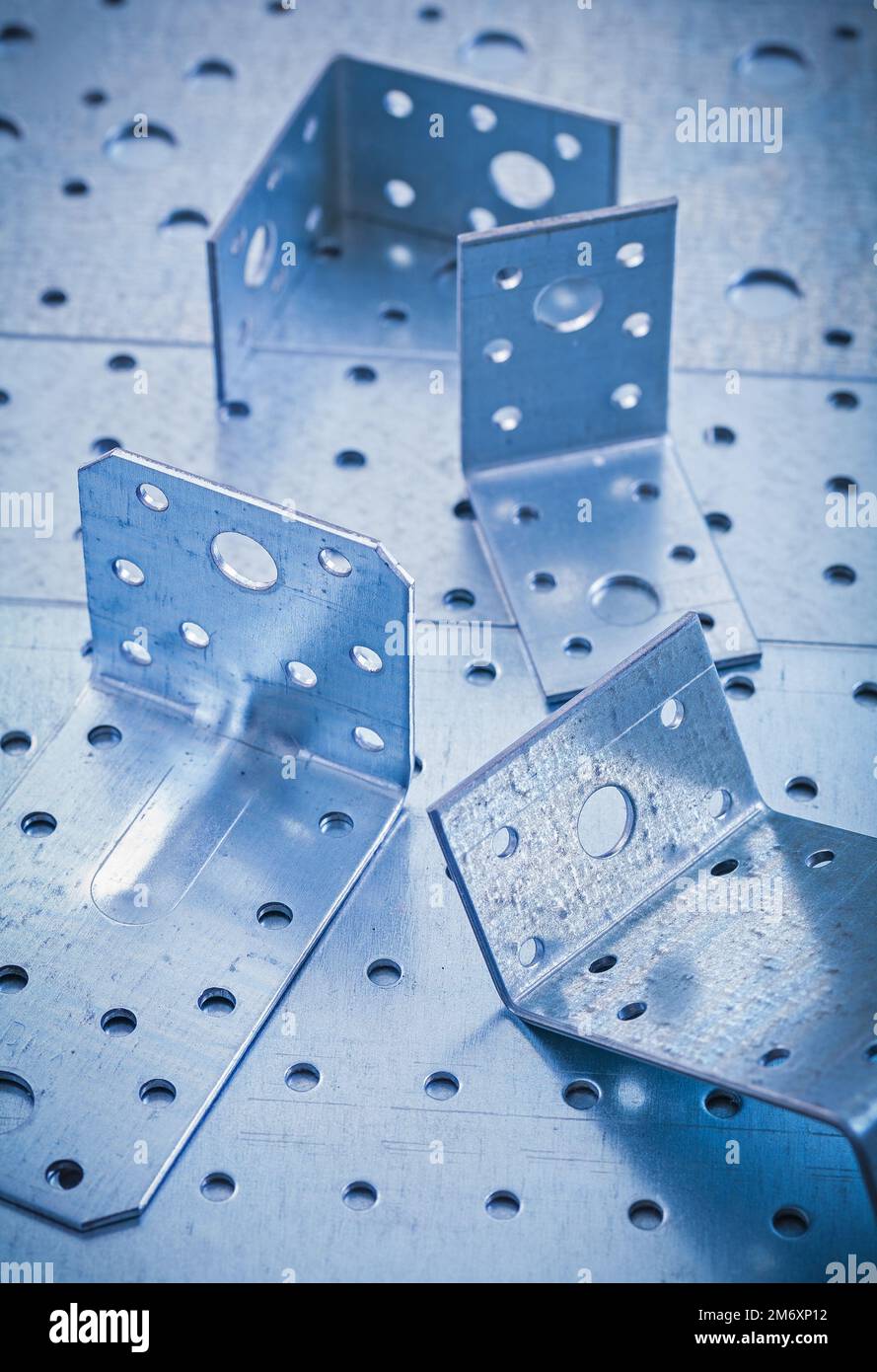 Metal angle bars on perforated metallic background construction concept ...
