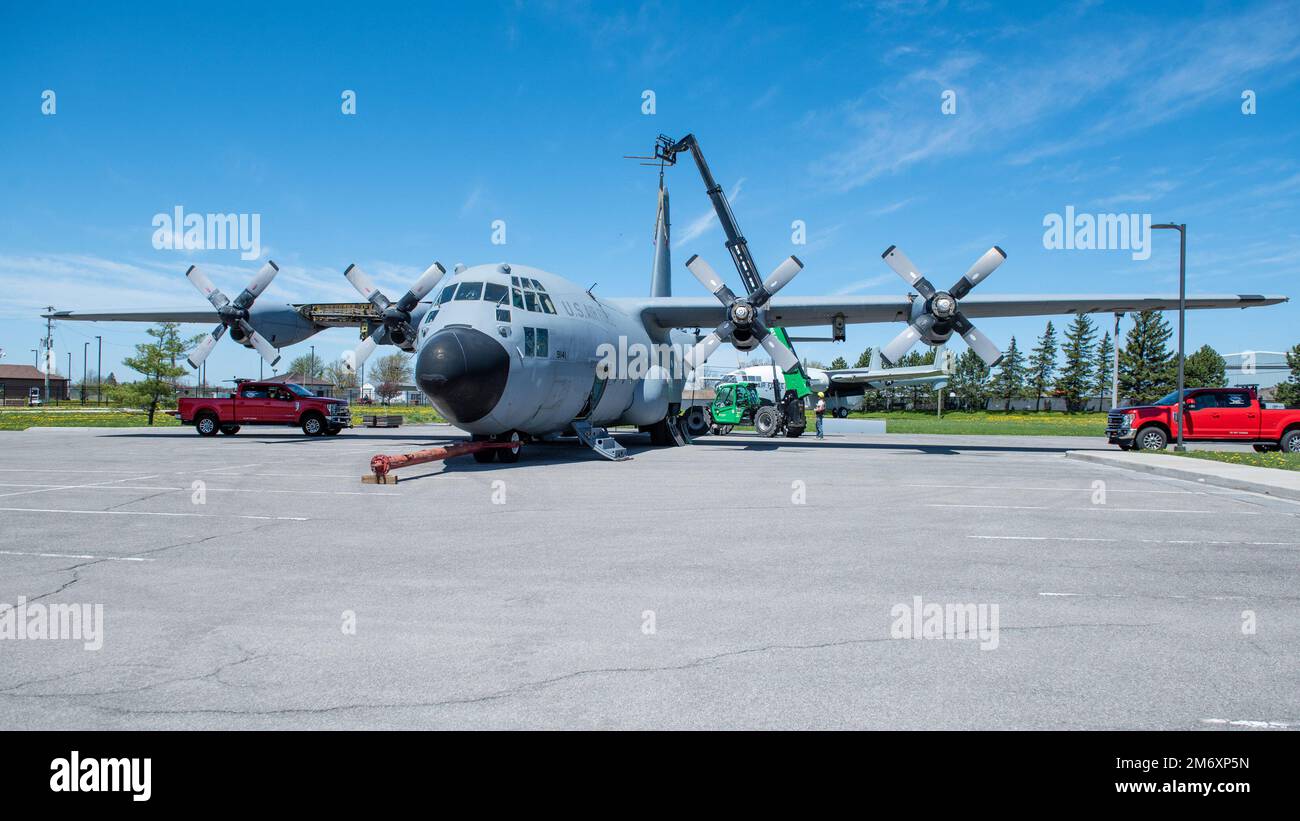 A C-130H Hercules transport plane is reassembled with both wings on in ...