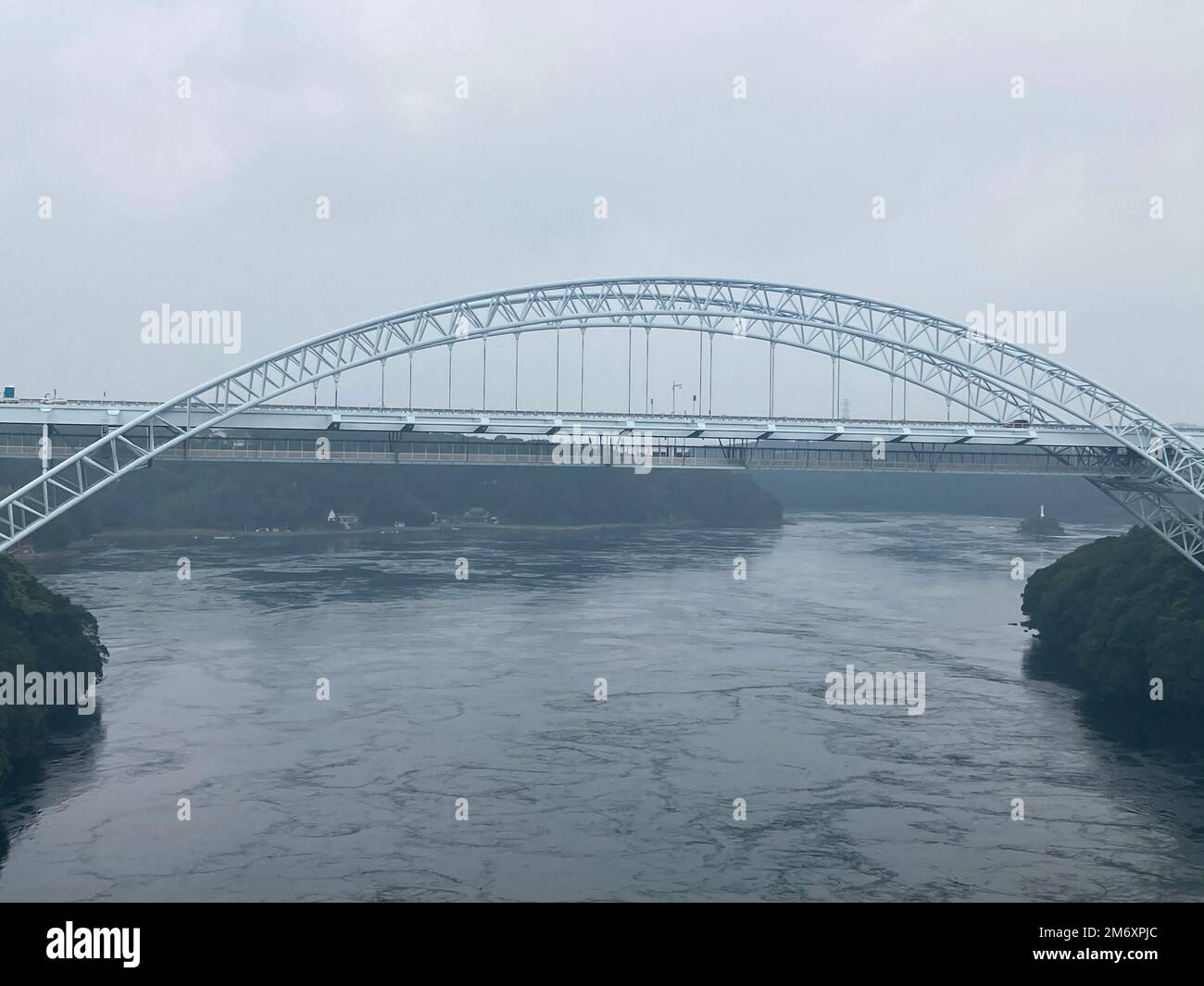 A beautiful shot of a steel arched bridge over water in Japan Stock ...