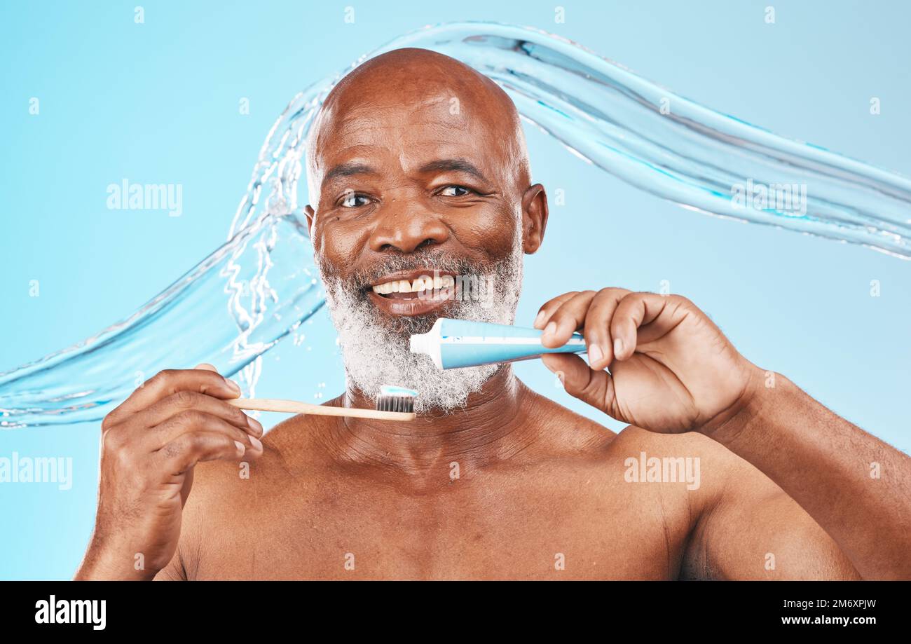Water splash, oral hygiene and portrait of a man in a studio for mouth health and wellness ...