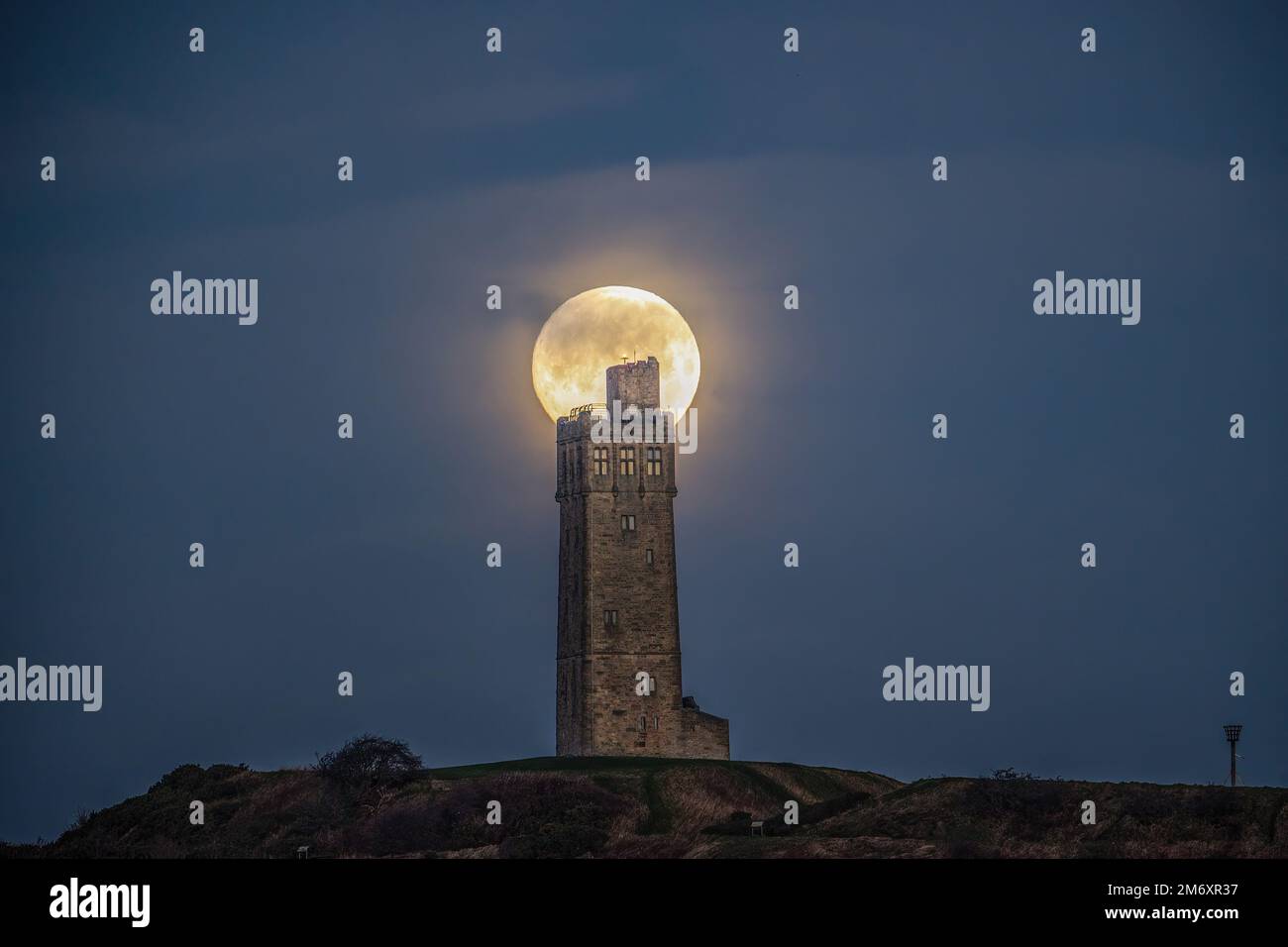 Wolf Moon sets at Victoria Tower Castle Hill near Huddersfield, West ...