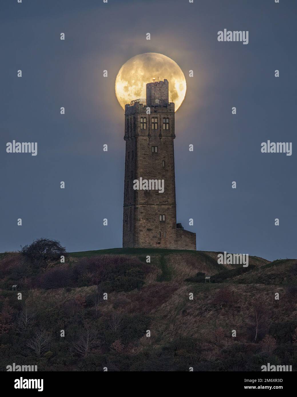 Wolf Moon sets at Victoria Tower Castle Hill near Huddersfield, West ...