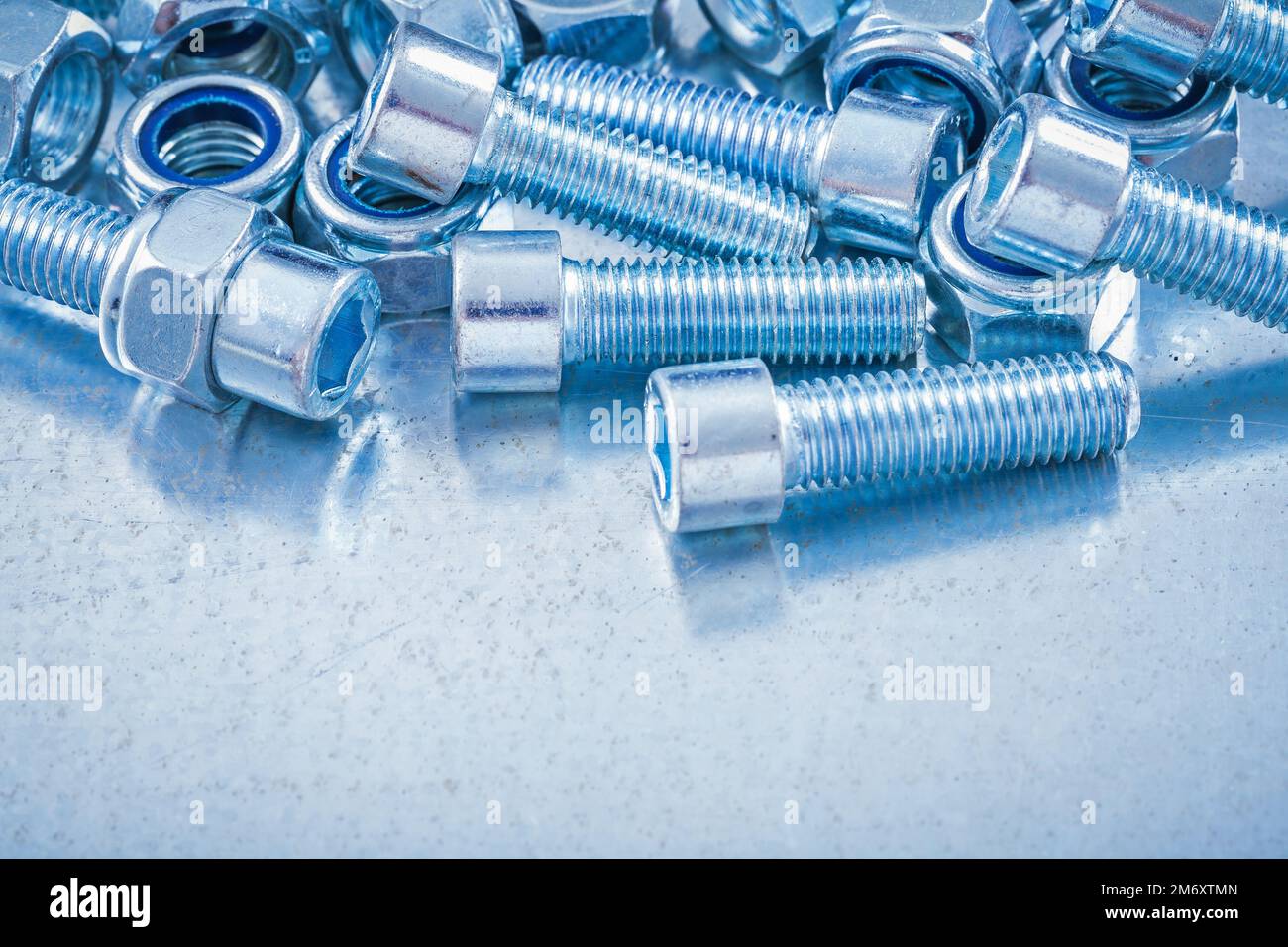Composition of metal screw nuts and screwbolts on flat metallic ...