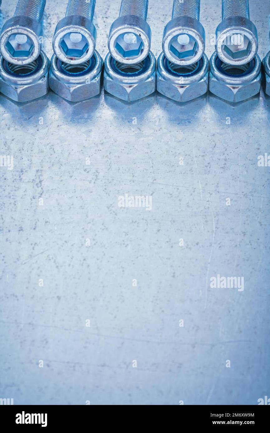 Group of threaded screw nuts and bolt details on metallic background ...