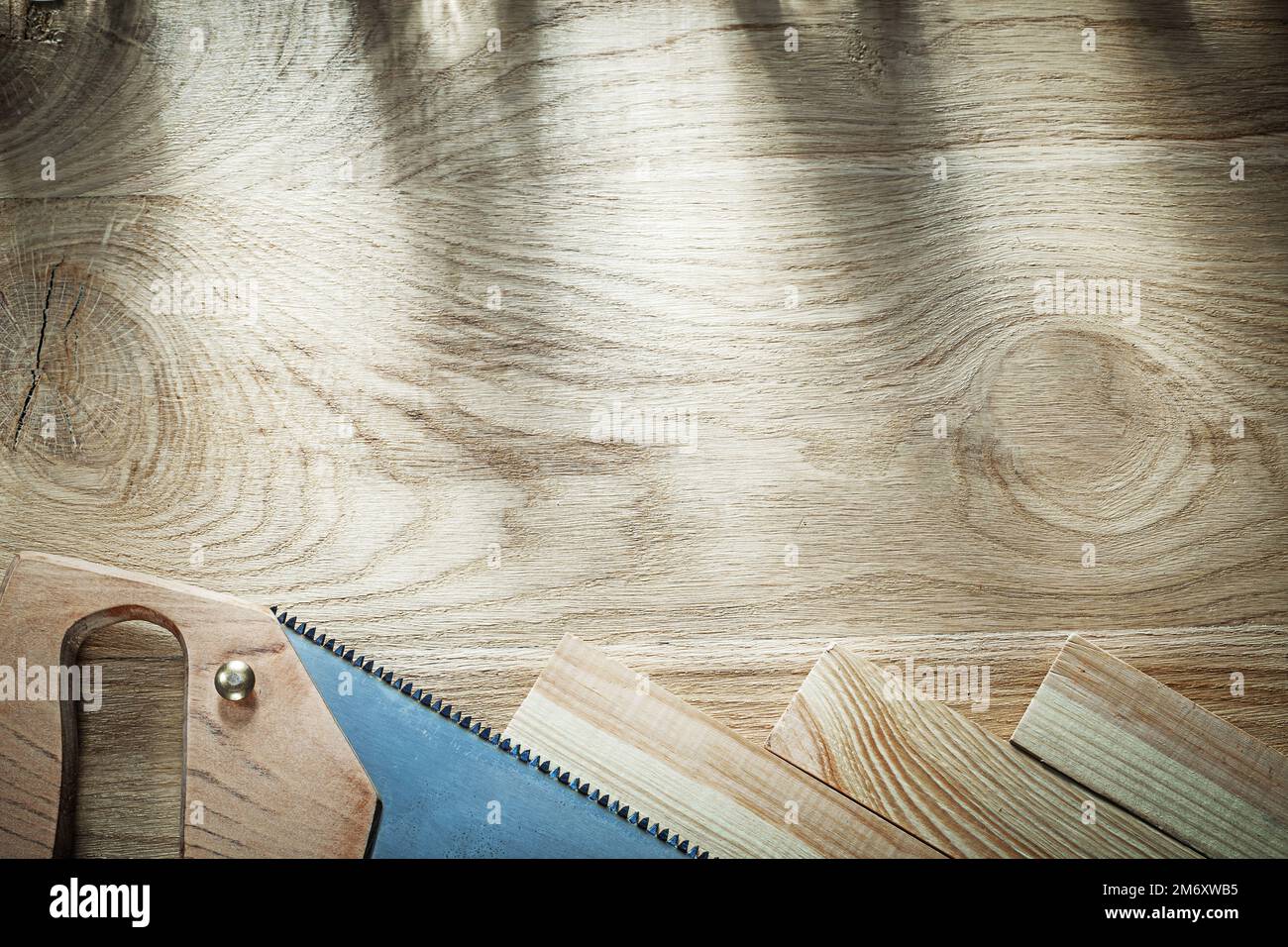 Hacksaw timber on wood board top view construction concept Stock Photo ...