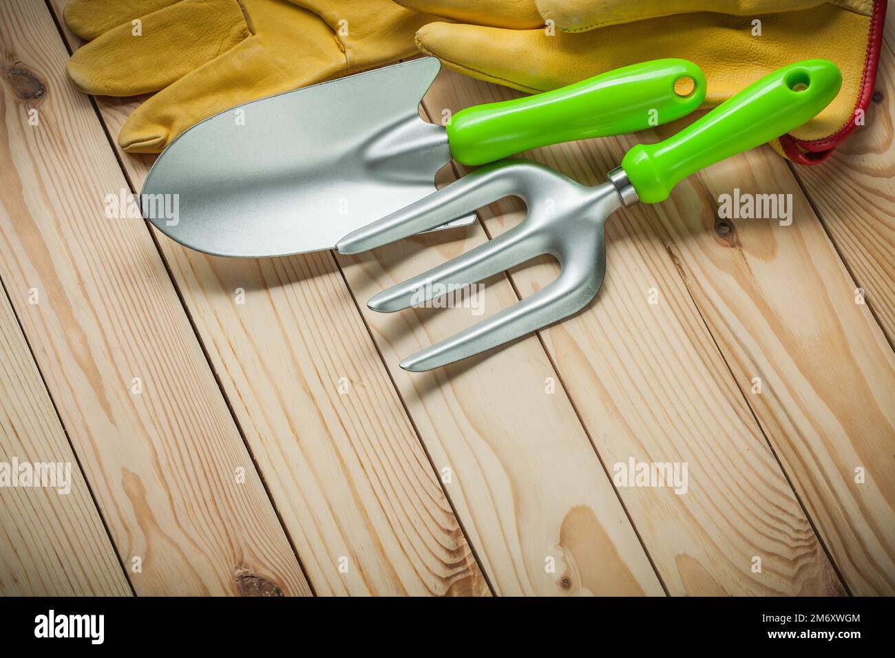 hand spade and fork with gloves on wood. garden tools Stock Photo - Alamy