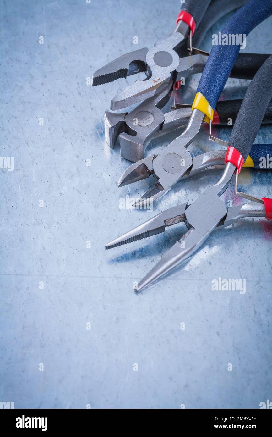 Insulated electric nippers on scratched metallic surface construction ...