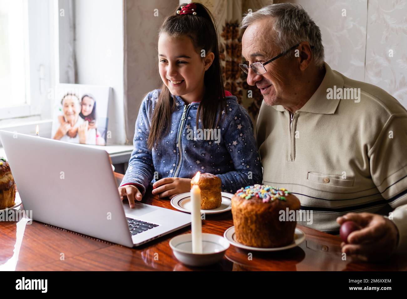grandfather and granddaughter are talking via video link to their ...