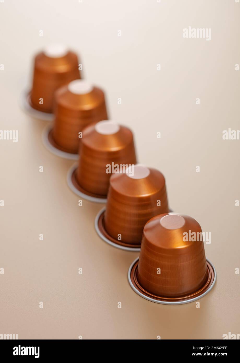 Aluminium coffee capsules pods for coffee machine on beige background ...