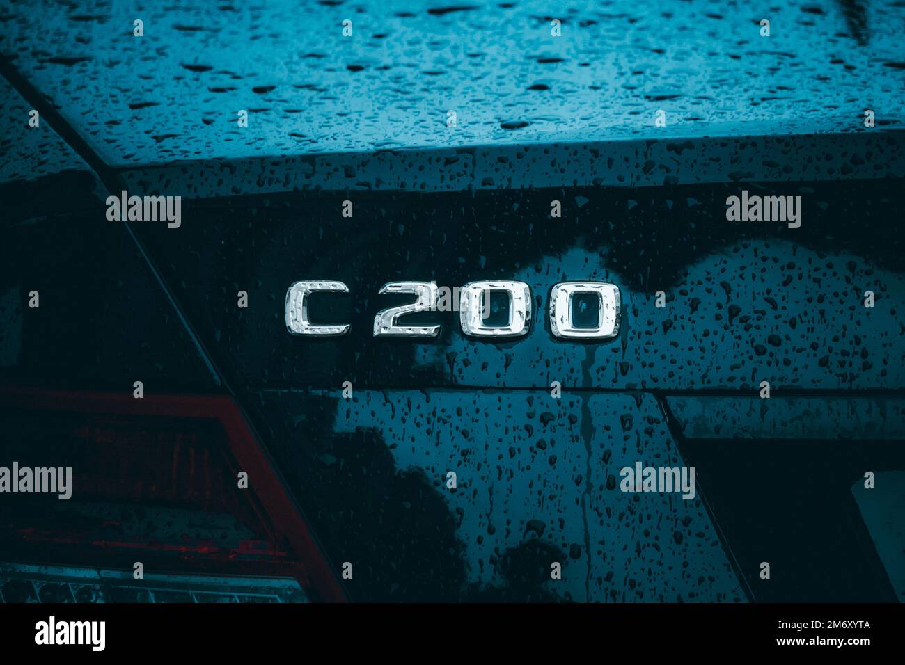 A closeup of a black Mercedes c200 logo detail on a rainy day Stock ...