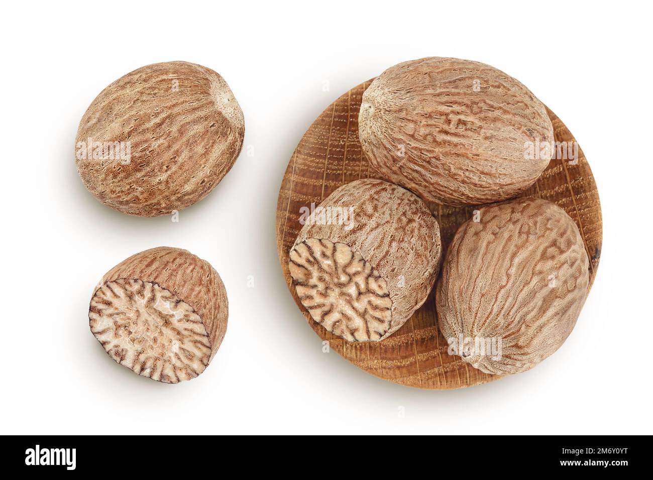 nutmeg in wooden bowl isolated on white background with full depth of ...