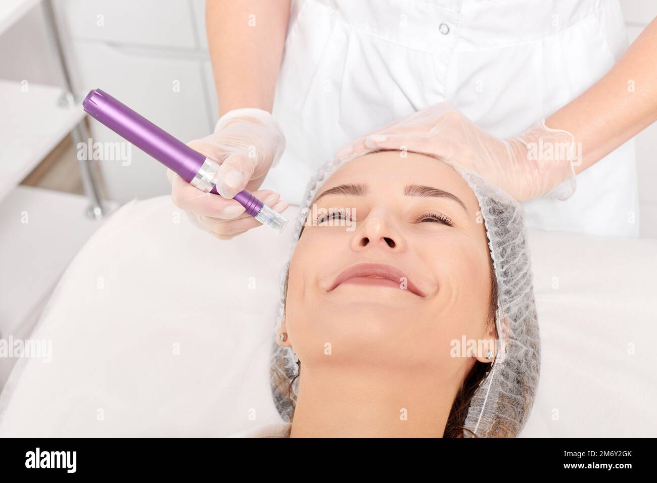 Cosmetologist makes mesotherapy injection for rejuvenation woman face ...