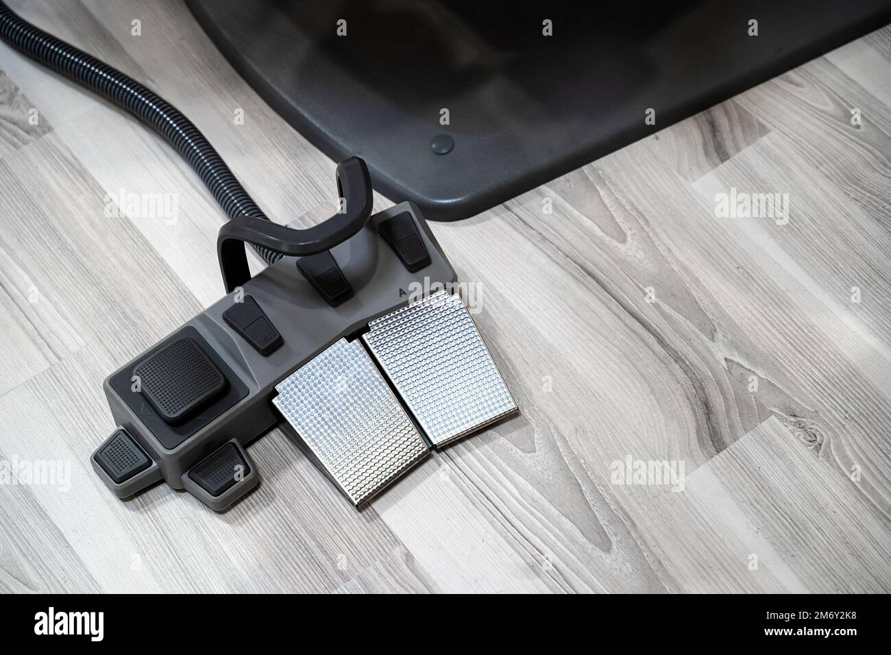 closeup top view of black dentist drilling control foot pedals near ...