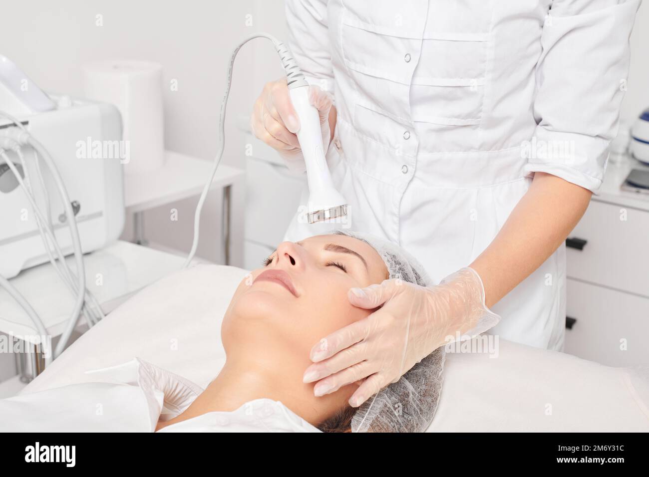 Beautician makes ultrasound skin tightening for rejuvenation woman face ...