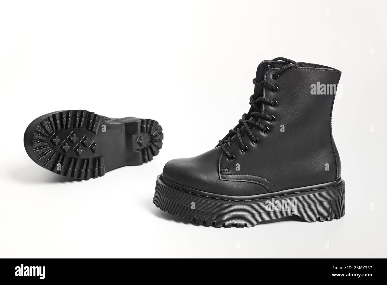 Black women combat boots on high heel platform with lug soles lying on ...