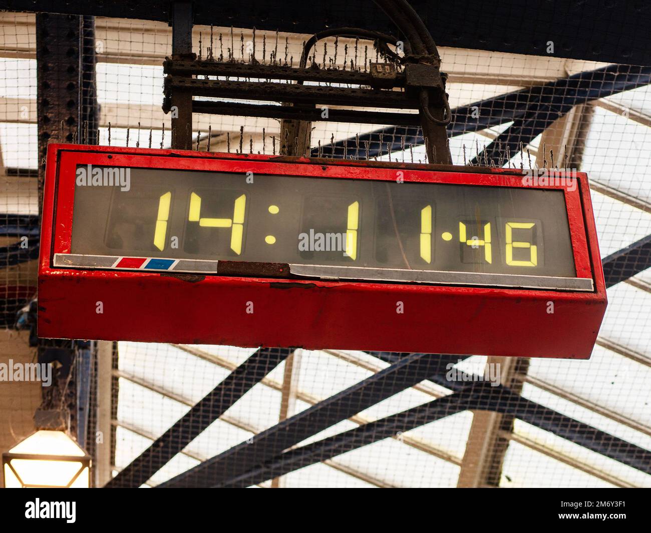 Victoria Station, London; the large digital clock hanging from the roof ...