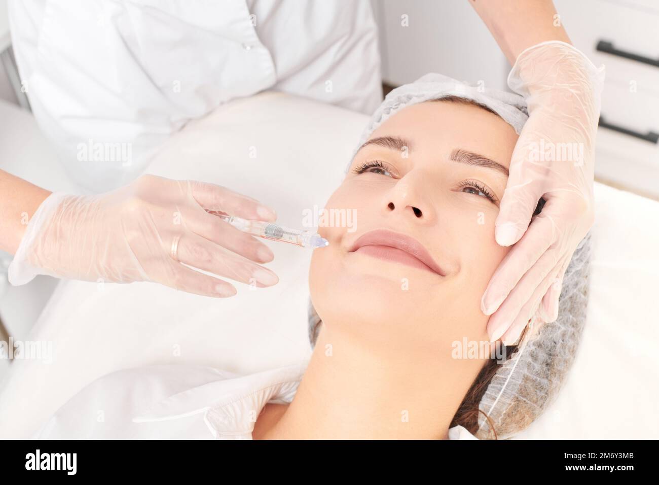 Cosmetologist makes fillers injection for lips augmentation and volume ...