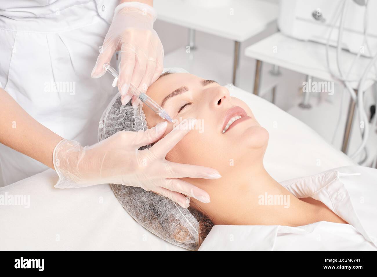 Cosmetologist makes rejuvenation injection in woman face skin, anti ...