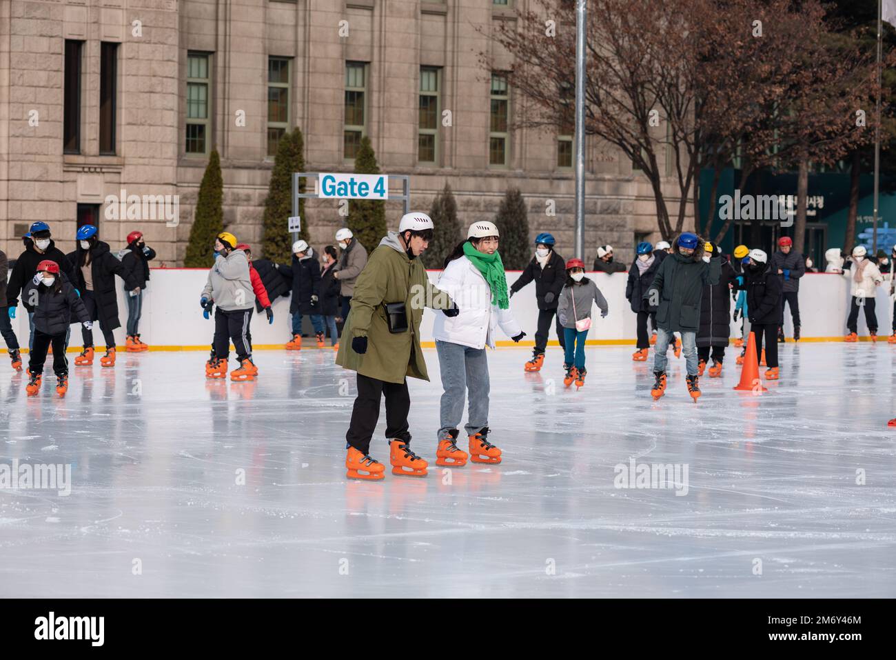 People ice skating on the temporary ice skating ring in front of the ...