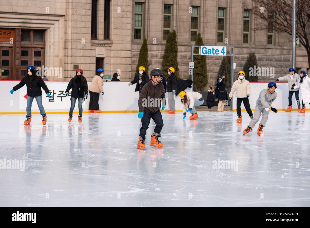 People ice skating on the temporary ice skating ring in front of the ...