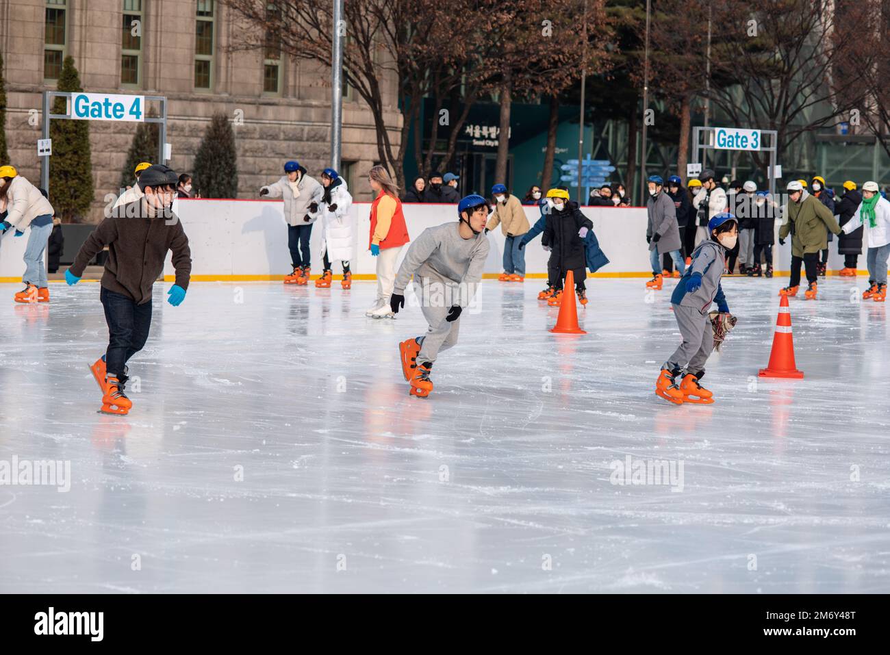 People ice skating on the temporary ice skating ring in front of the ...