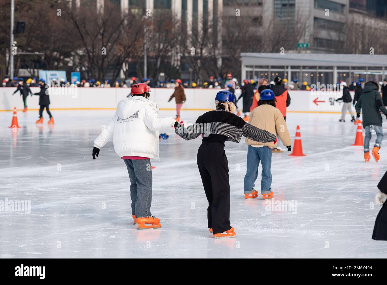 People ice skating on the temporary ice skating ring in front of the ...