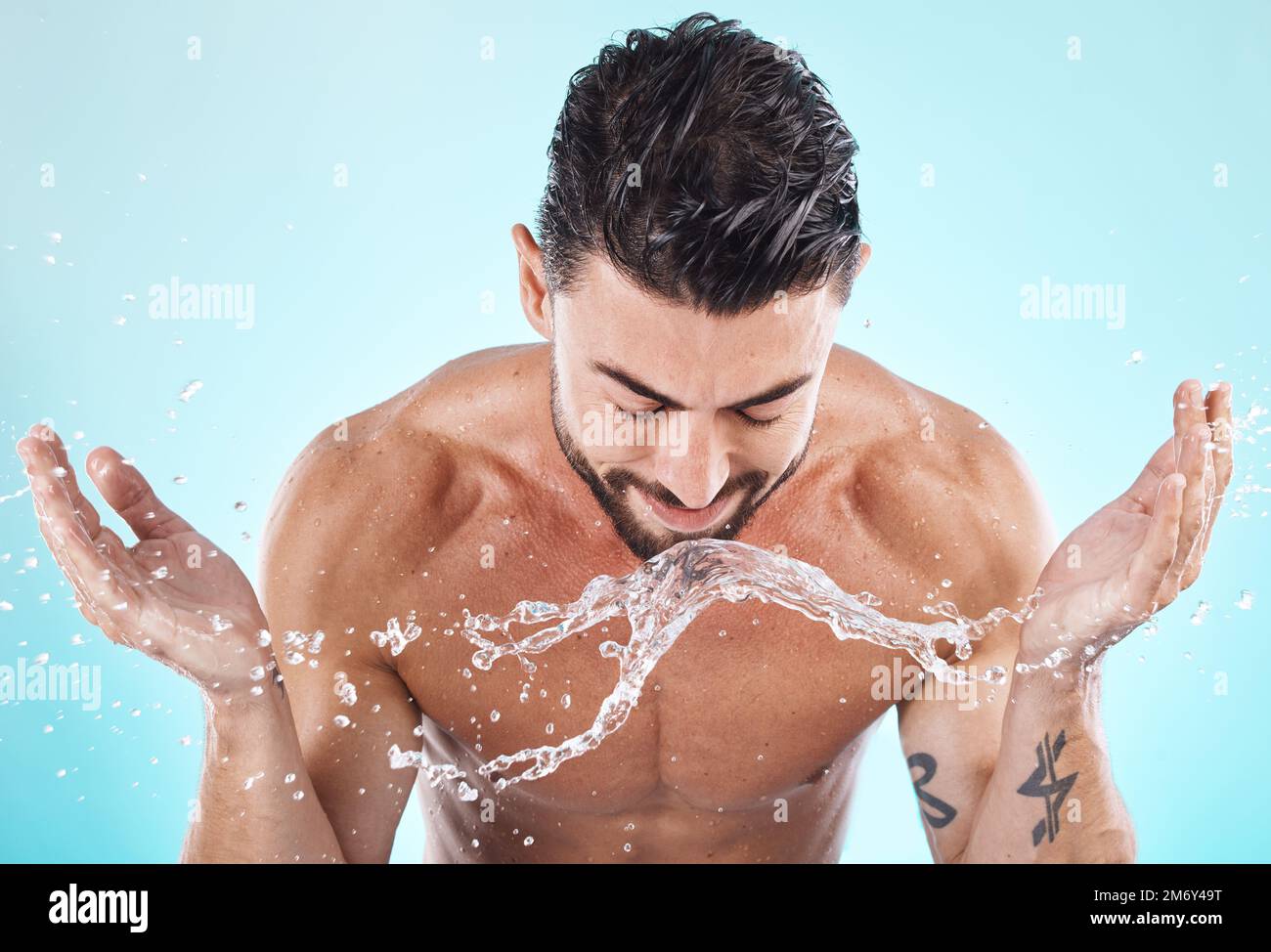 Skincare, water splash and man in a studio for a wellness, health and ...