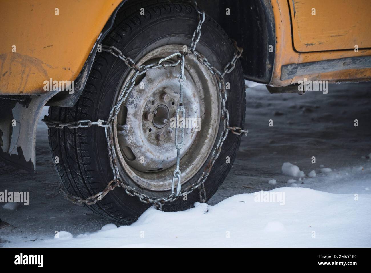 Wheel passenger car is clad in chains for driving on ice Stock Photo ...