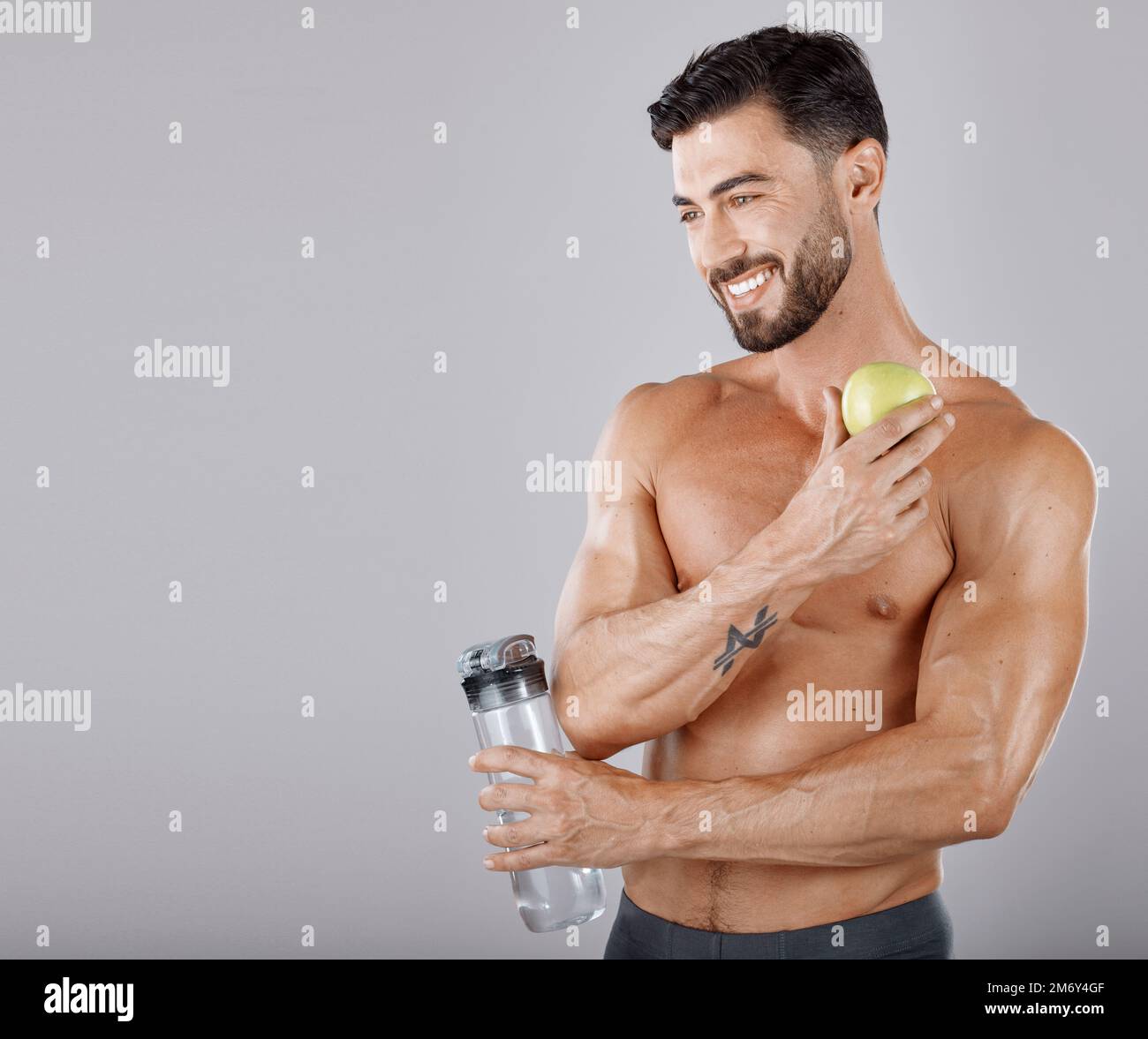 Man, water bottle and apple for healthy lifestyle, diet and wellness in ...