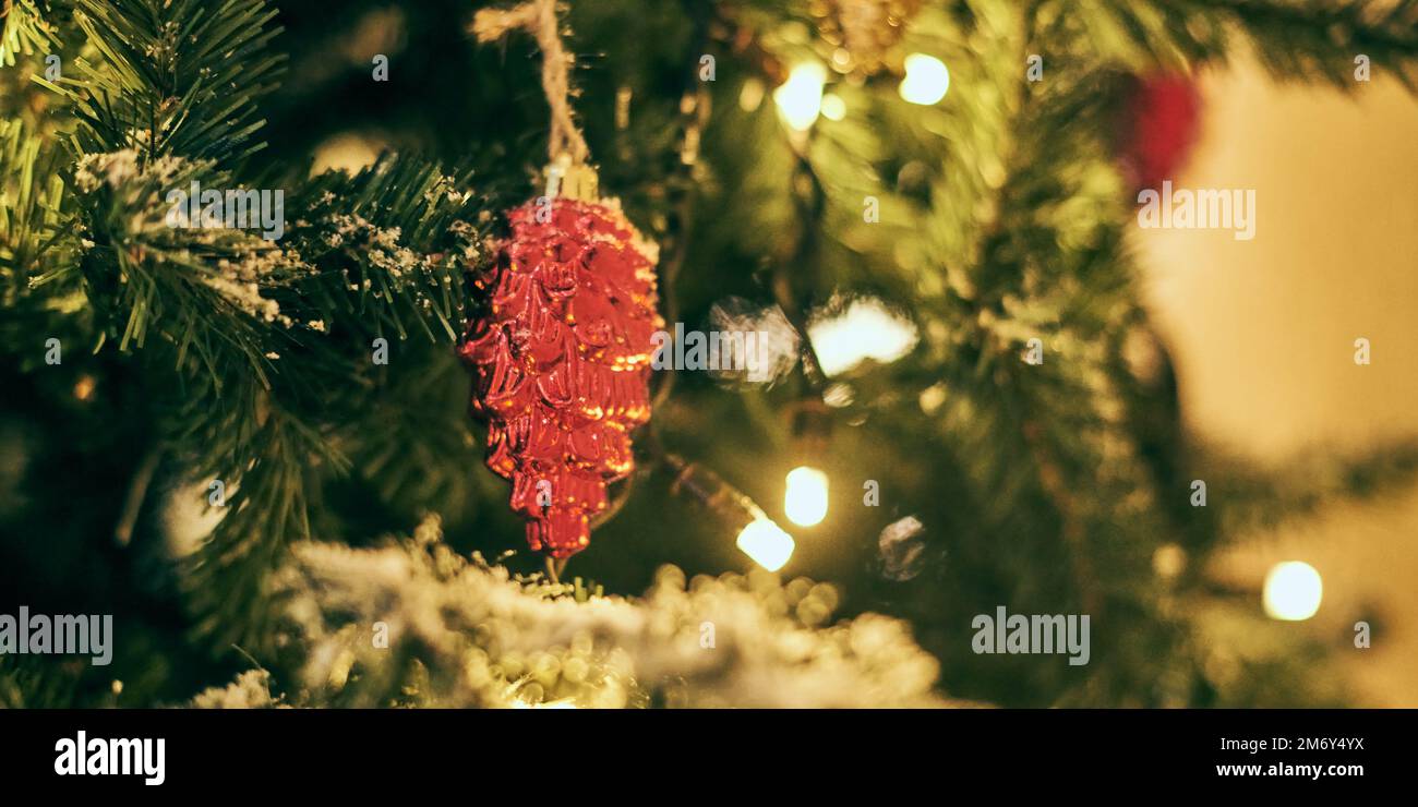 Christmas tree bulbs with yellow garlands covered snow, outdoor xmas ...