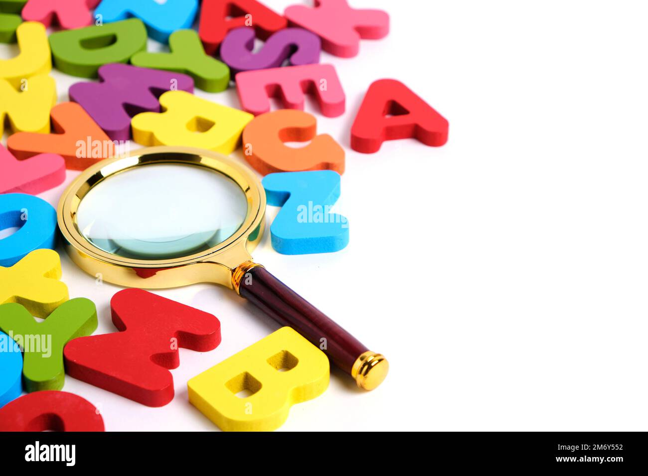 Magnifying glass and bright multicolored letters English alphabet white ...