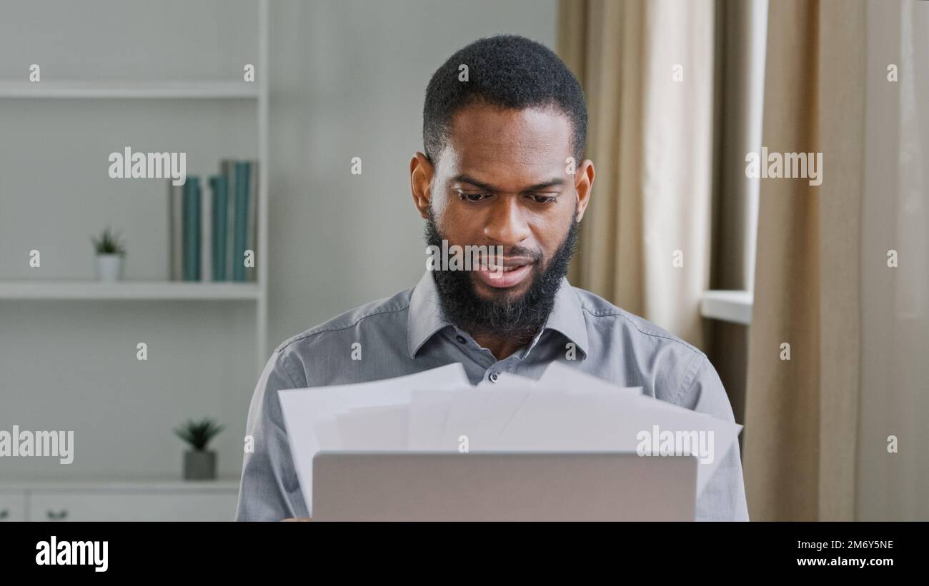 Pensive millennial ethnic bearded male office worker analyzing ...