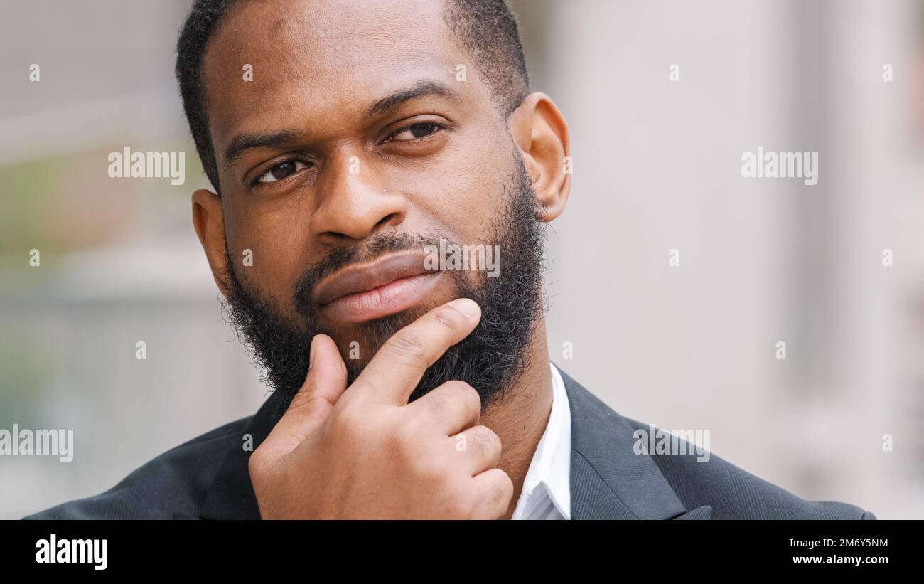 Pensive thoughtful thinking bearded African American ethnic businessman ...