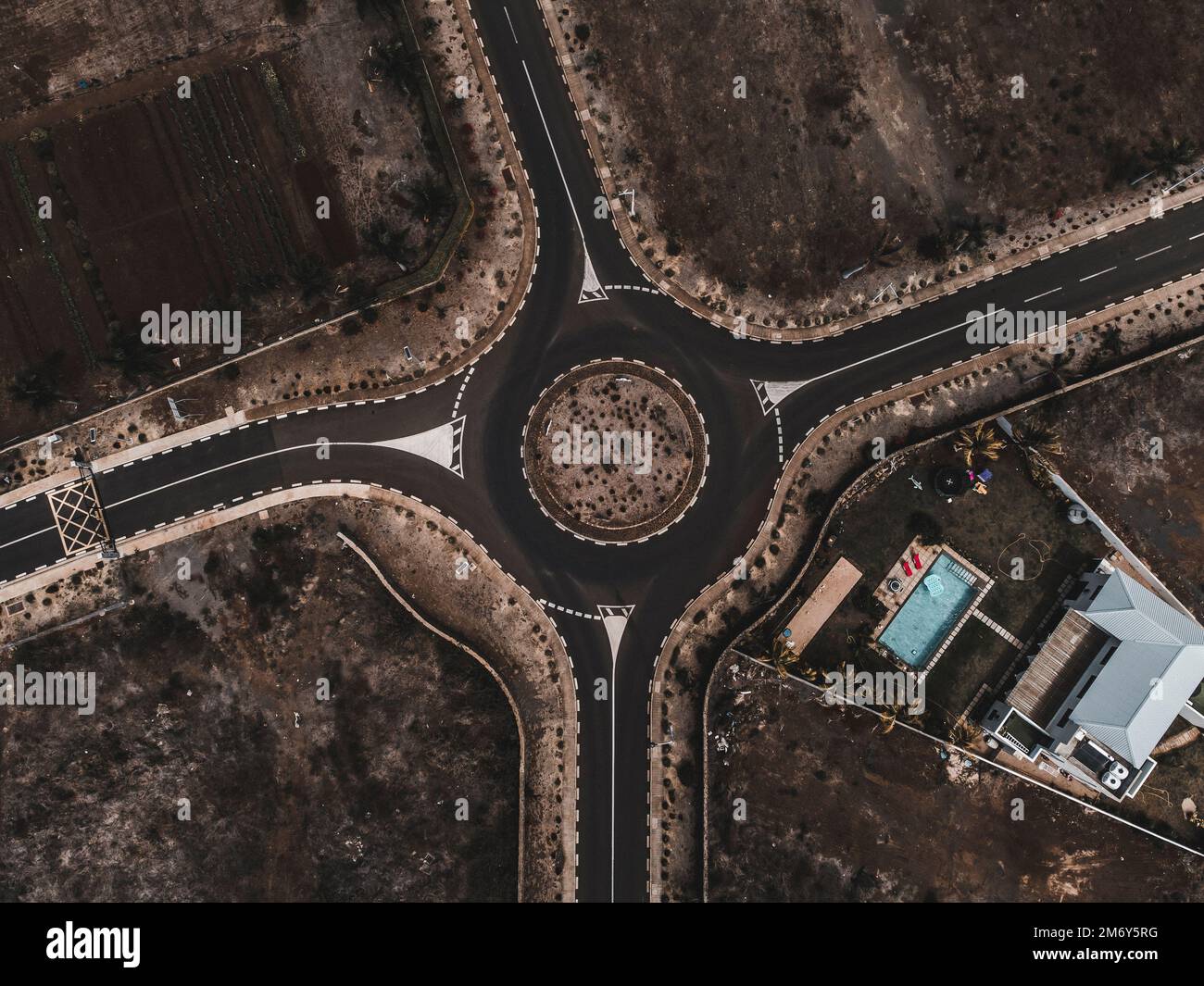 An aerial view of roundabout surrounded by greenery fields Stock Photo - Alamy