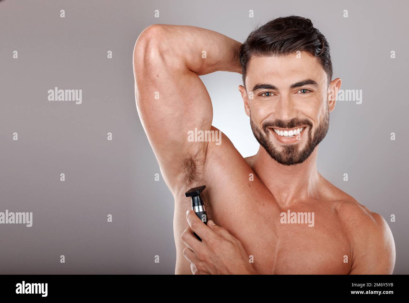 Face, man and armpit shaving for skincare in studio isolated on a gray background mockup ...