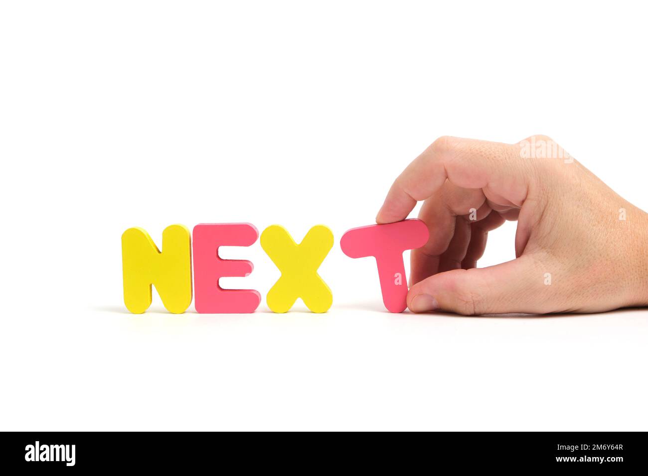 Man hand composes the word next in letters on white background Stock ...
