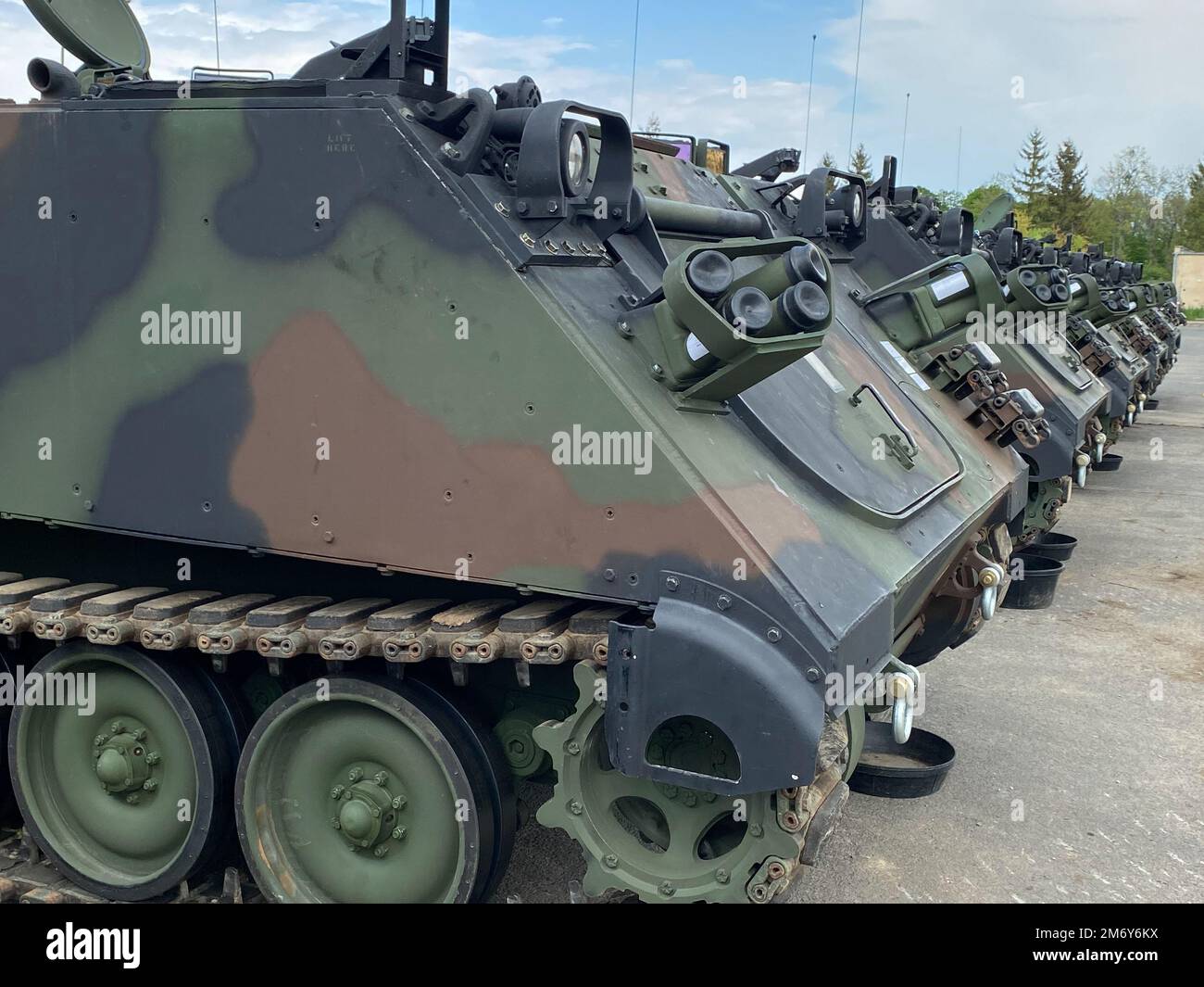 A line of M113 armored personnel carriers stand at the ready at the ...