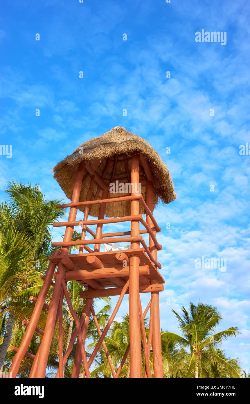 Wooden lifeguard tower on a Caribbean beach against the sky with ...