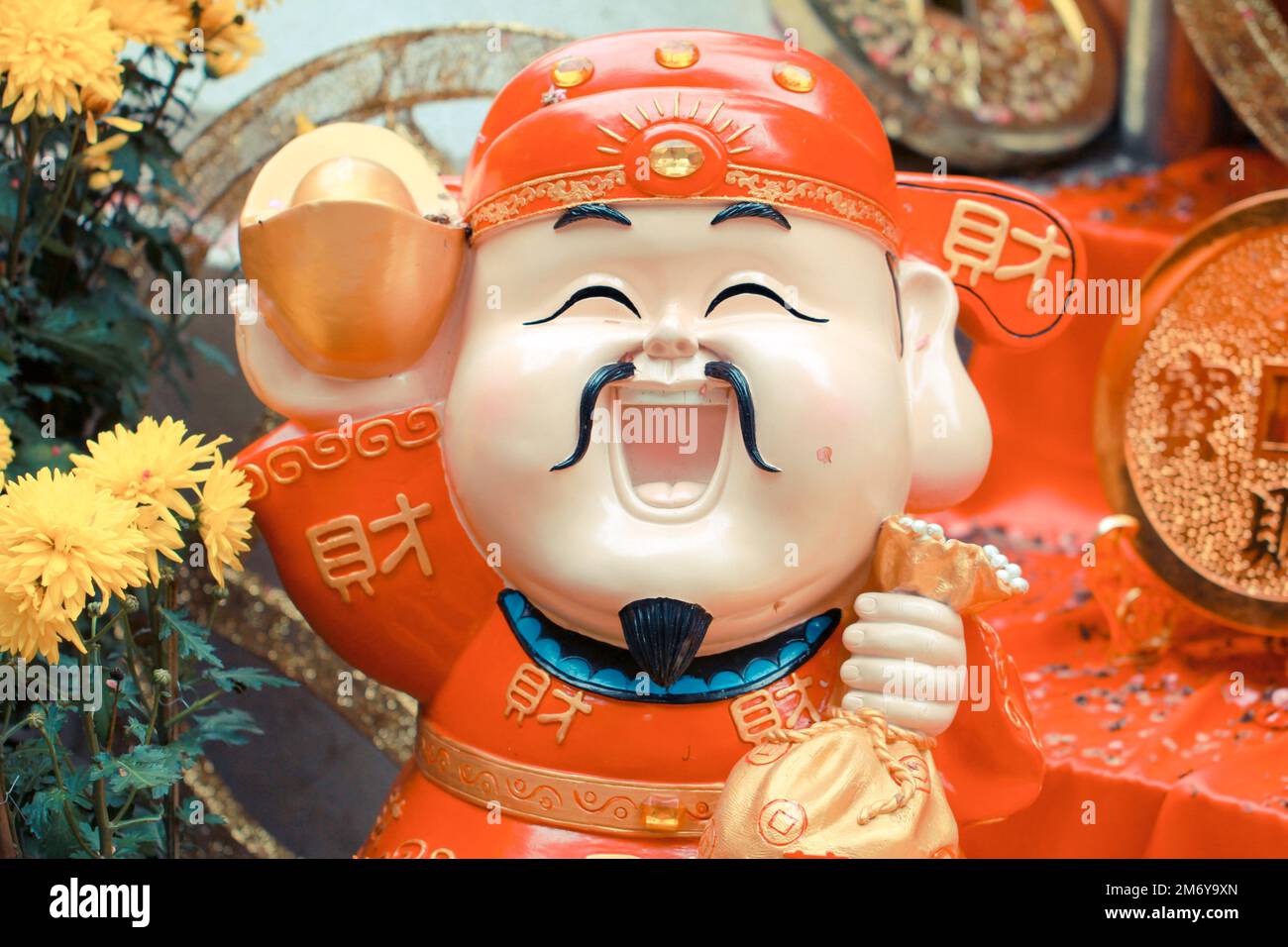 A closeup of a traditional Chinese decorative man with characters at a ...