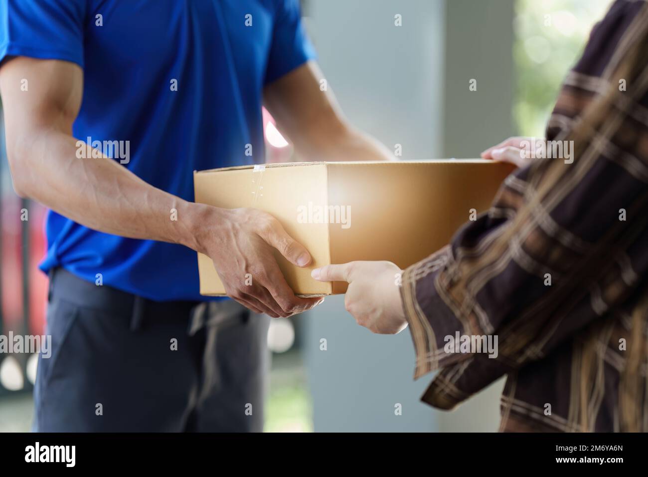 Asian courier with parcel and delivery logistic concept. Delivery man ...