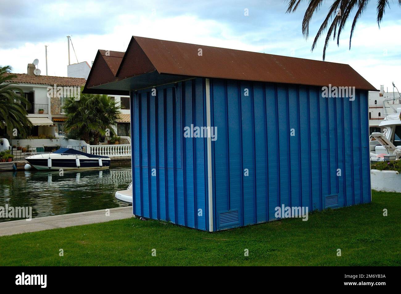 Blue Shack in the grass near the channel Stock Photo - Alamy