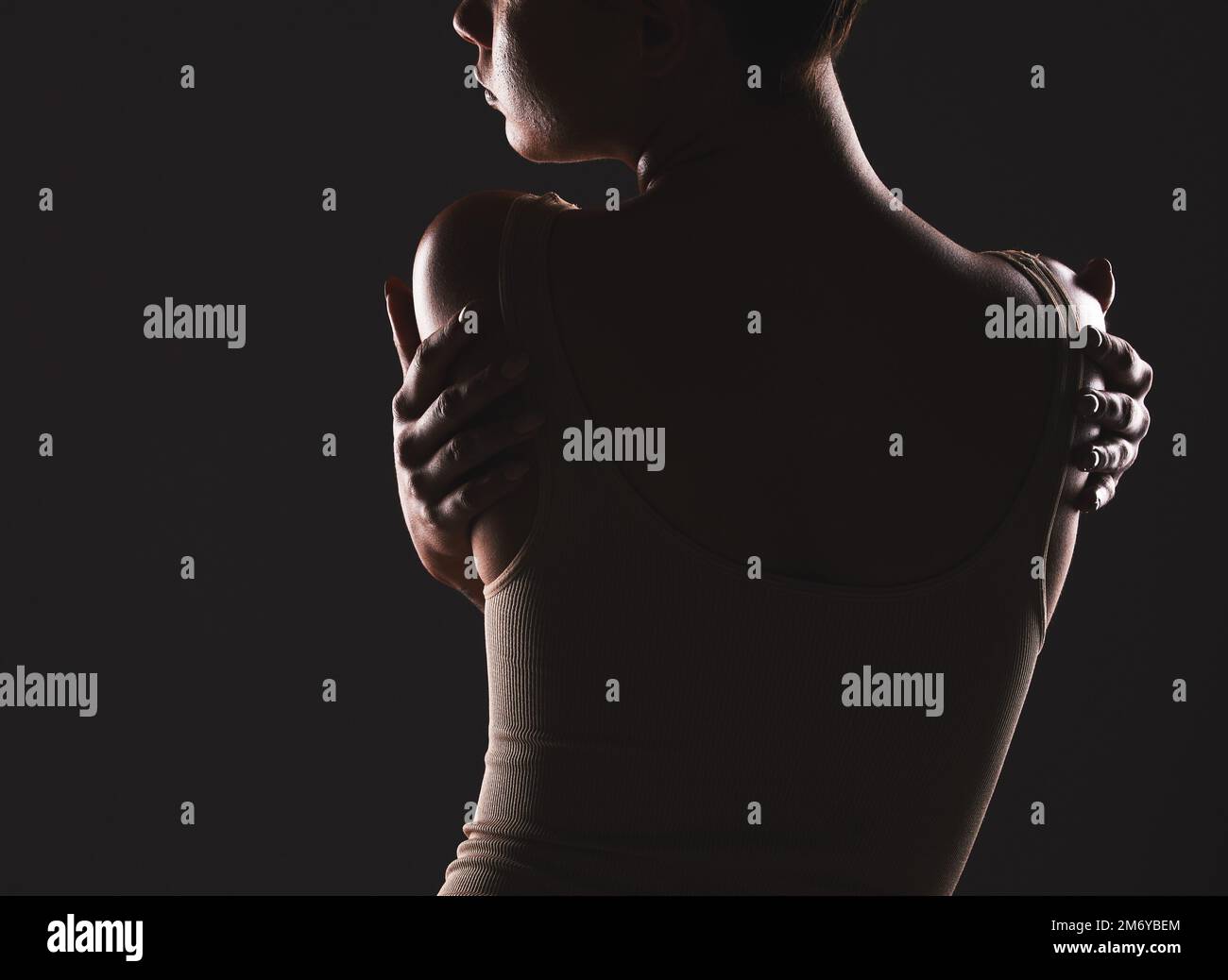 Beauty, back and dark with a model woman posing in studio on a black ...