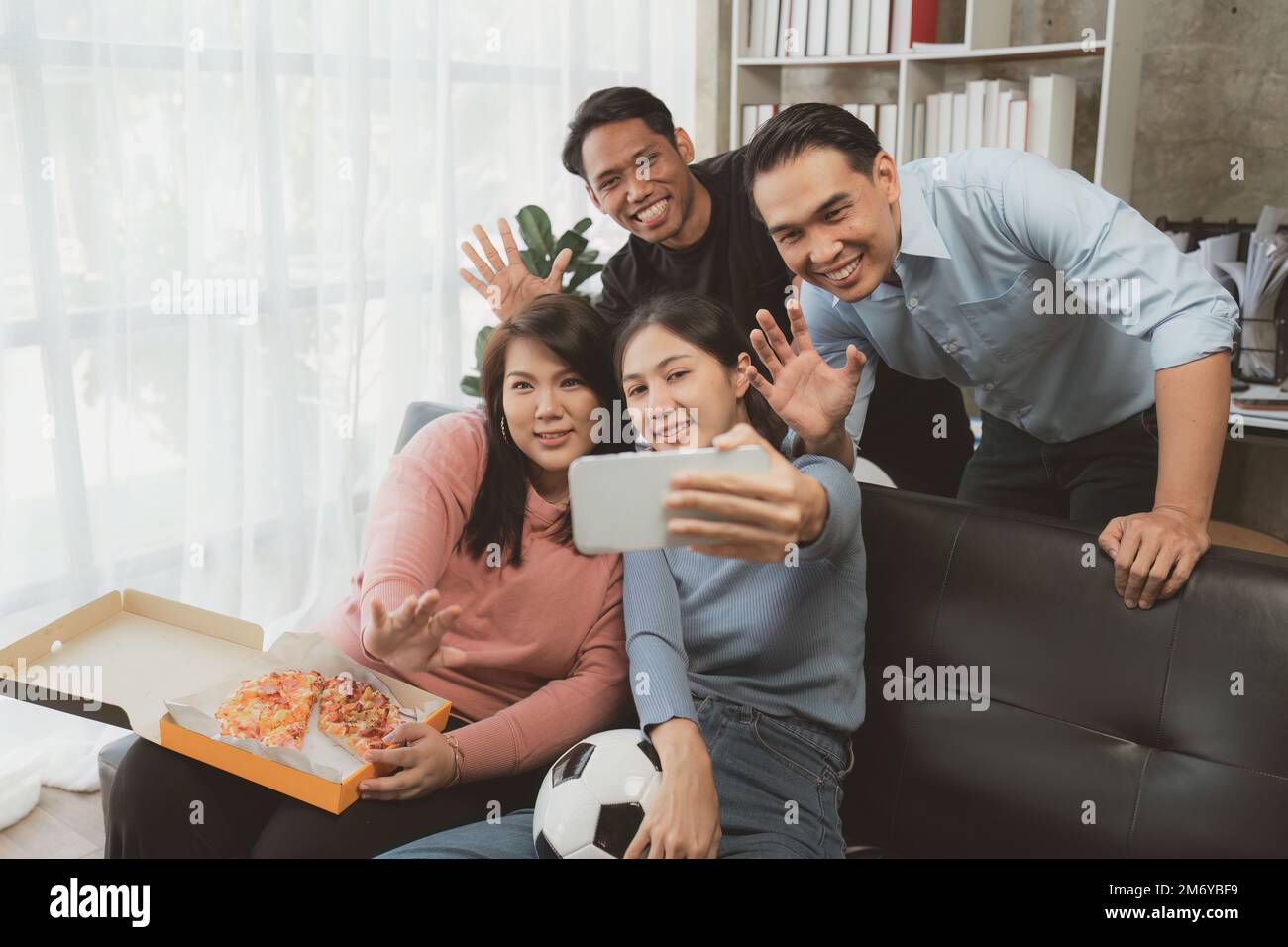 Excited friends having fun by watching football or soccer match and ...